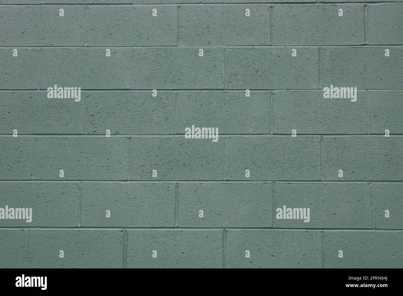Green painted cinder block wall serves as textured background Stock ...
