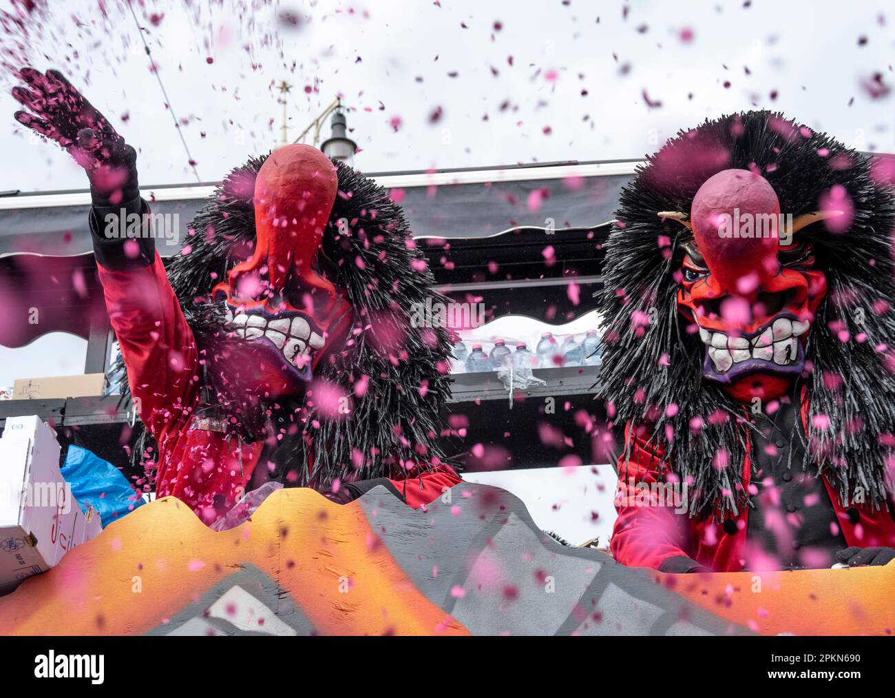Waggis costume inside a parade float throwing confetti at the Basel ...