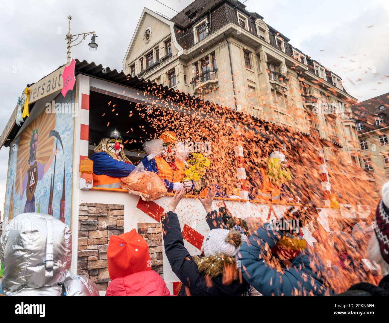 Waggis costume inside a parade float throwing confetti at the Basel ...