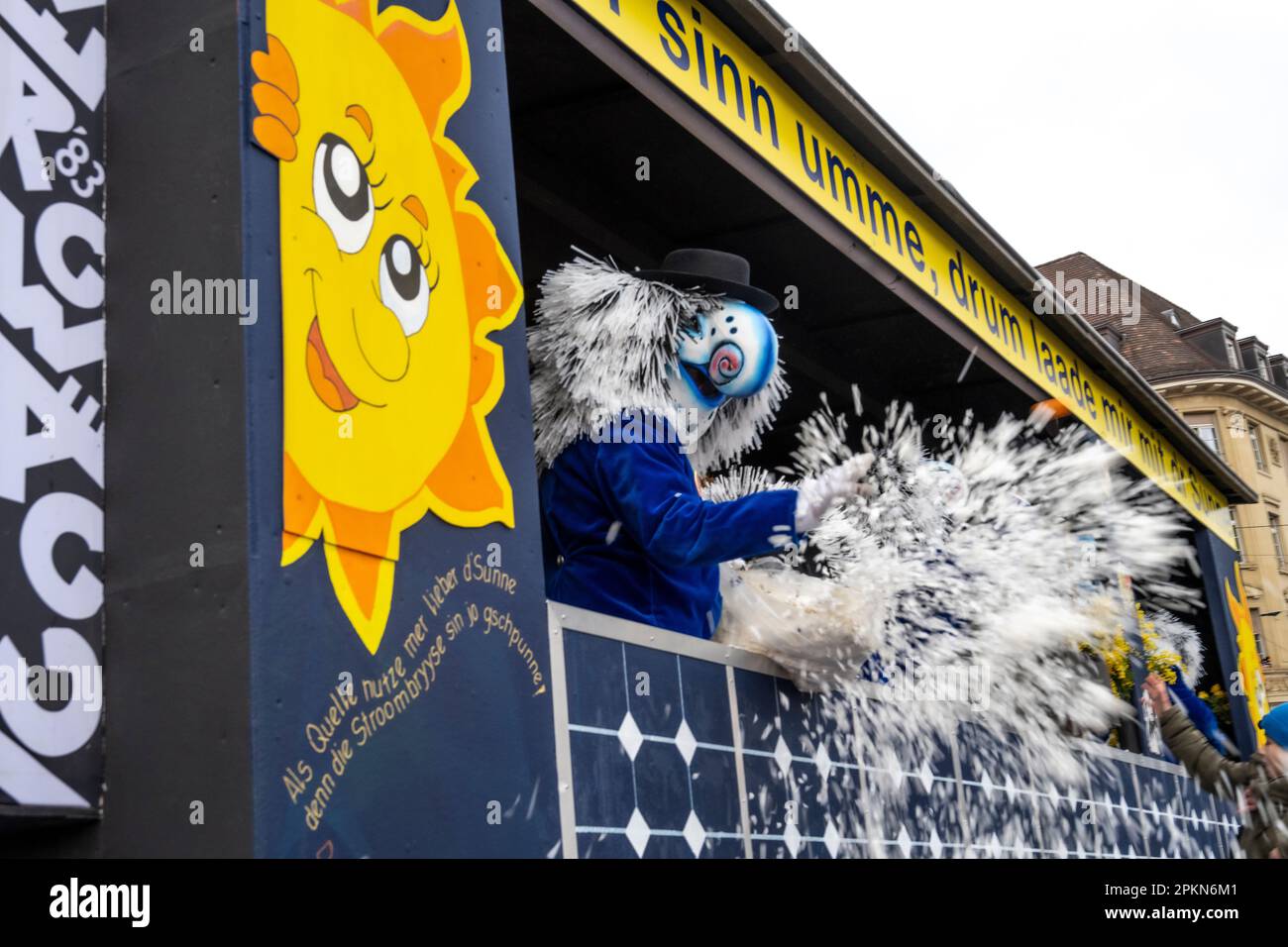 Waggis costume inside a parade float throwing confetti at the Basel ...