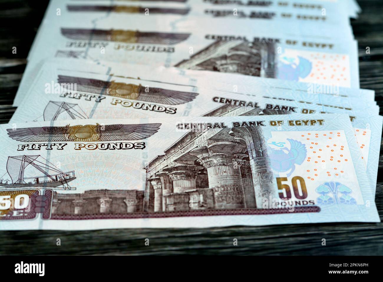 Egypt money stack of pounds isolated on wood background, pile of 50 EGP ...