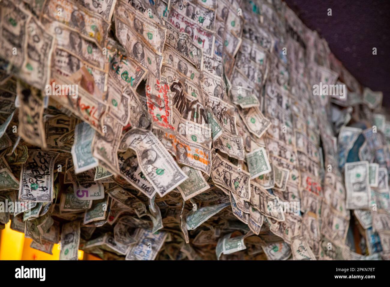 Wall of Dollar Bill Tips Signed Stock Photo - Alamy