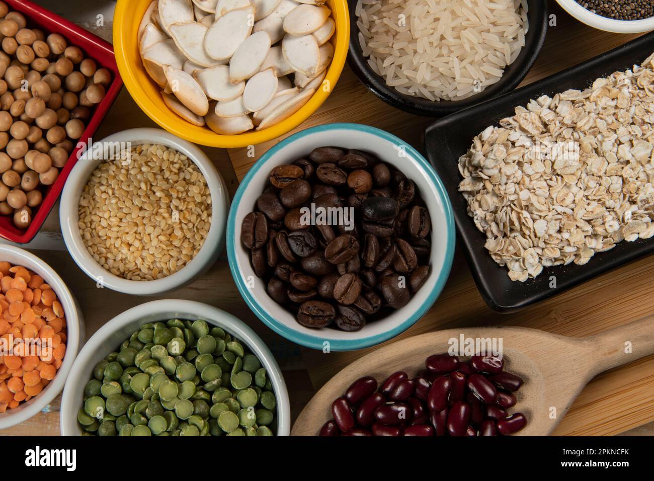 Different types of legumes in bowls, green and yellow peas, chickpeas ...