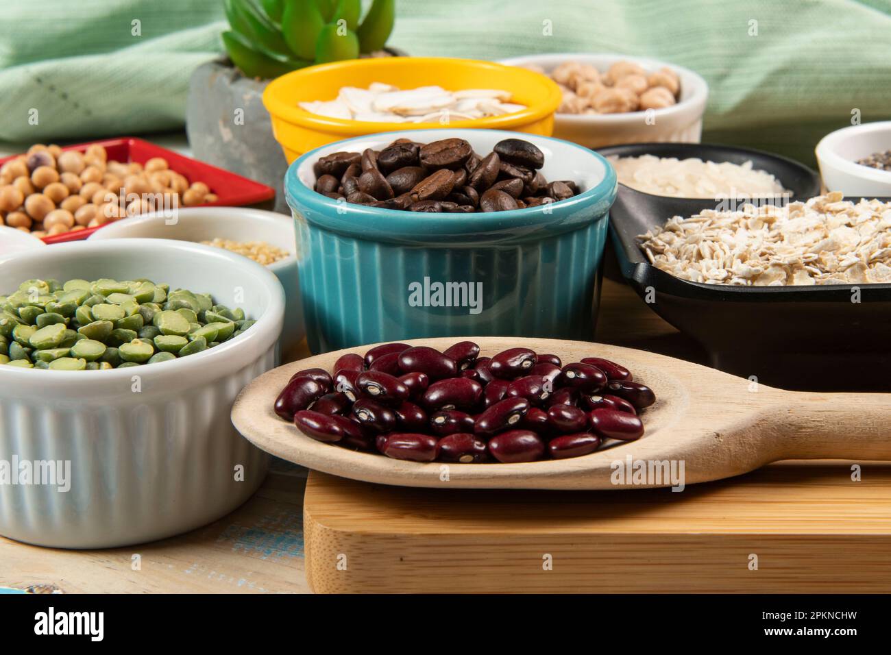 Different types of legumes in bowls, green and yellow peas, chickpeas ...