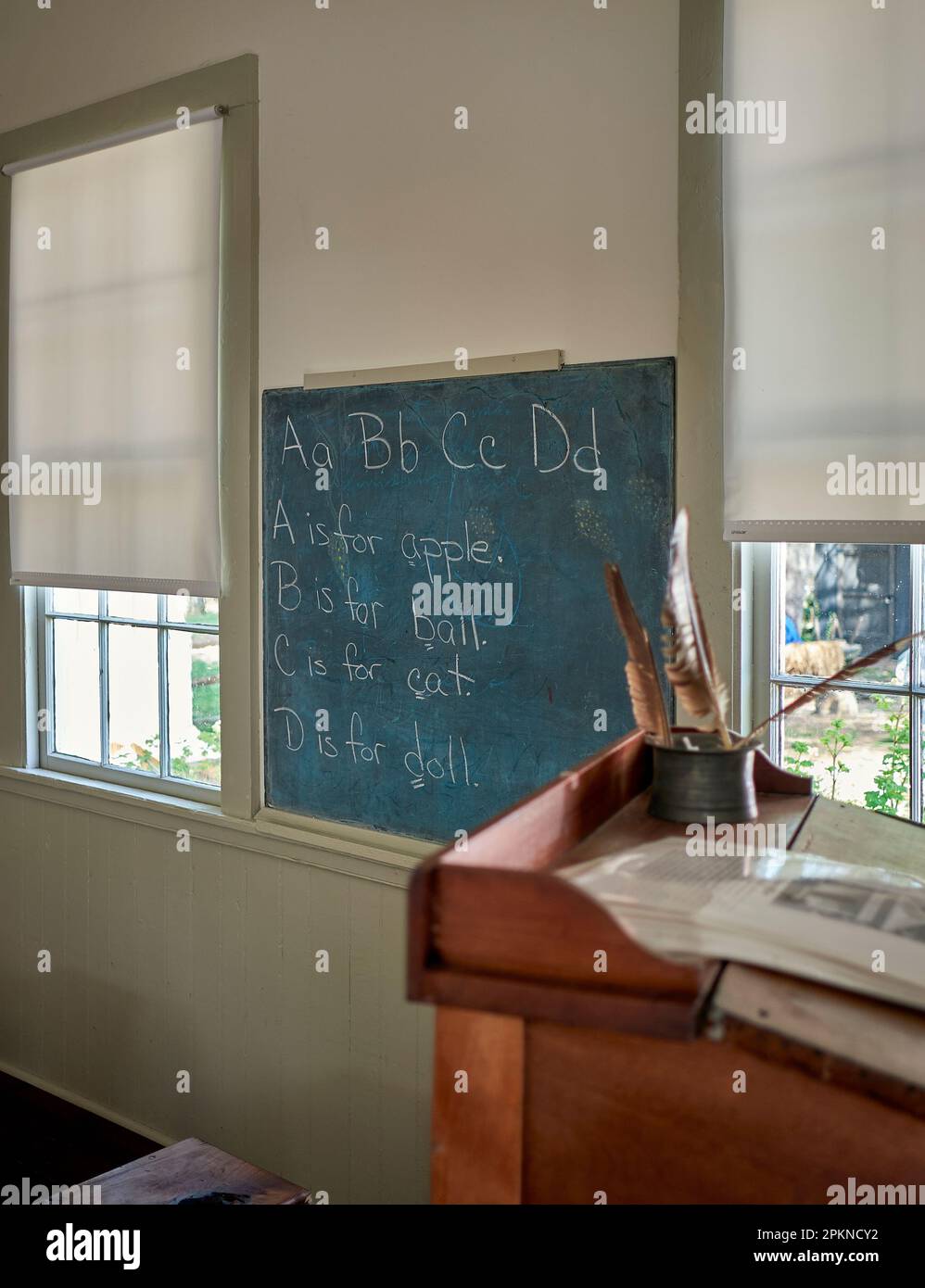 Interior view of a restored antique, one room schoolhouse, showing a teacher's desk and a ...