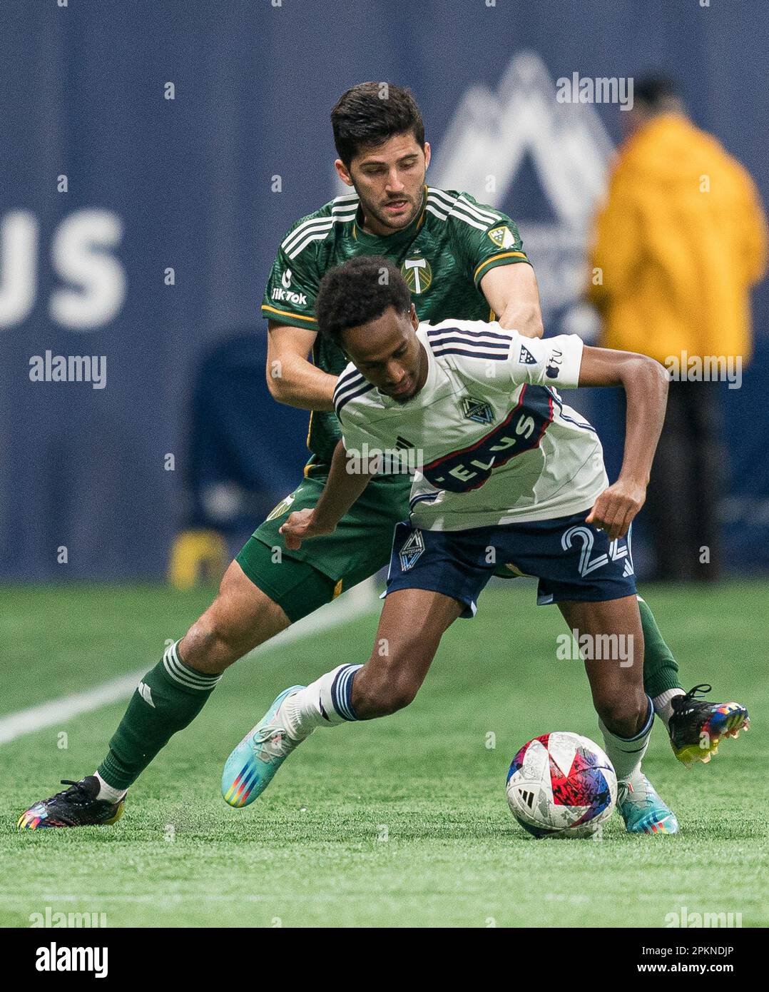 Vancouver Whitecaps' Ali Ahmed, right, gets pushed to the turf by ...