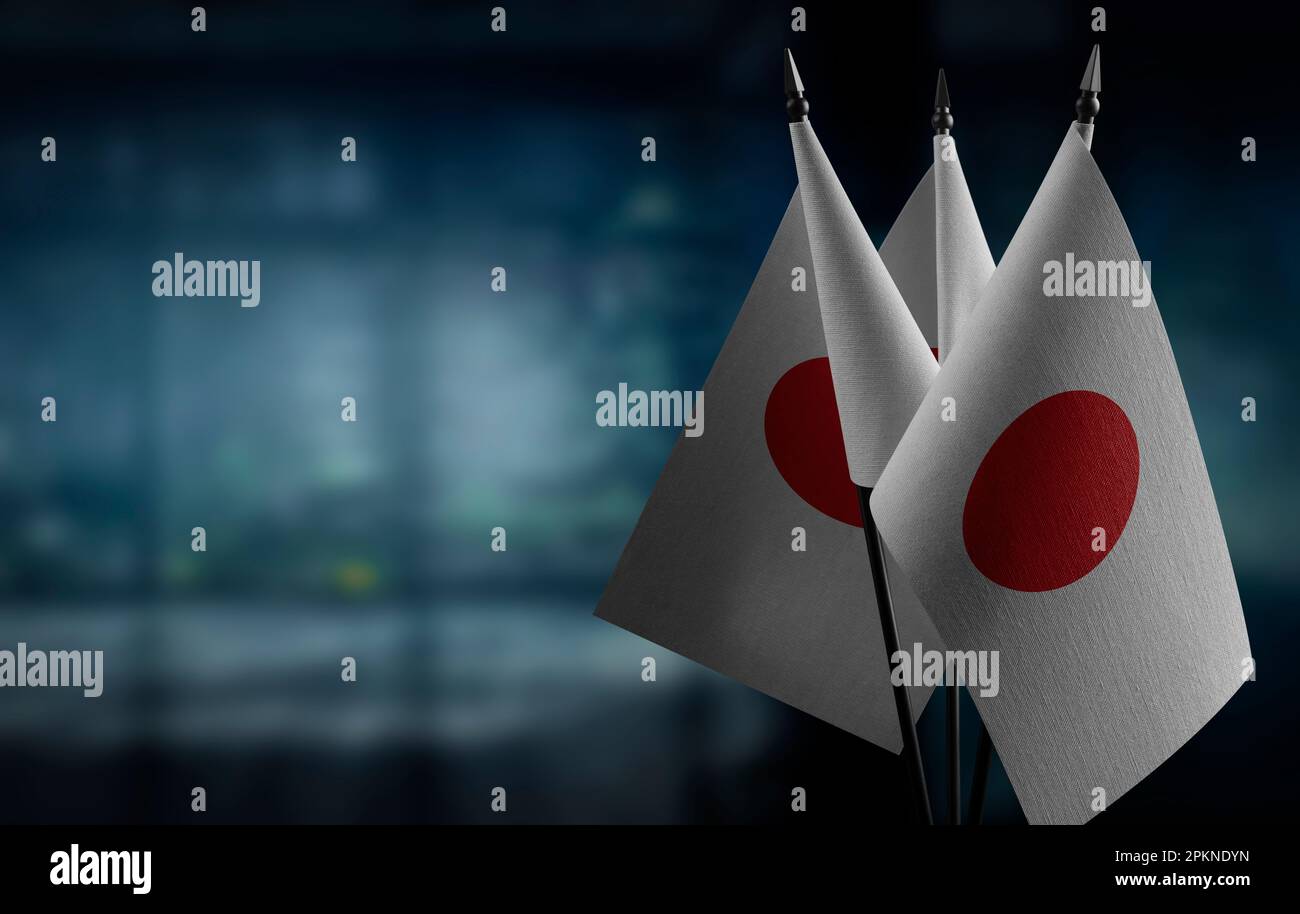 Small flags of the Japan on an abstract blurry background Stock Photo ...