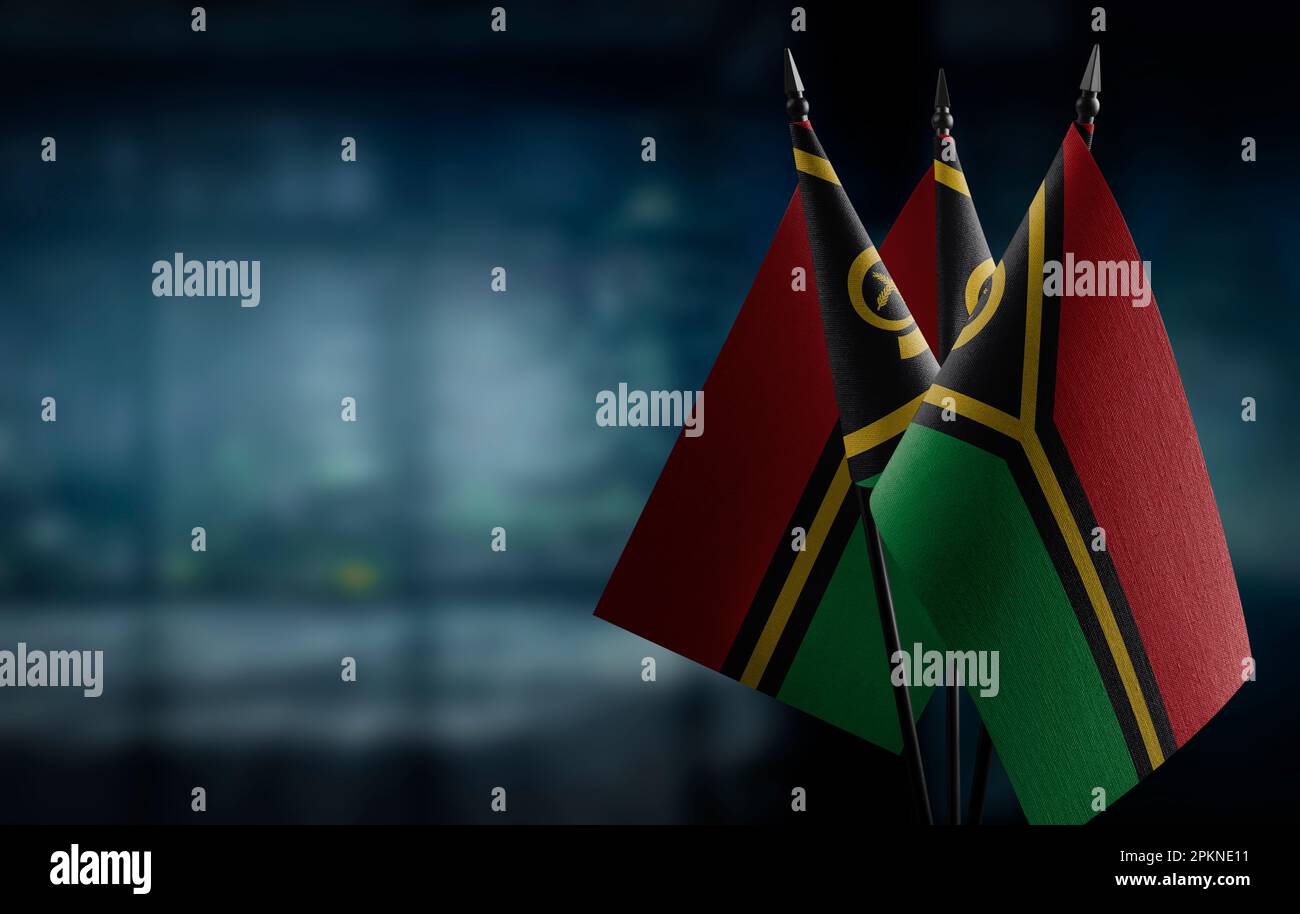 Small flags of the Vanuatu on an abstract blurry background Stock Photo ...