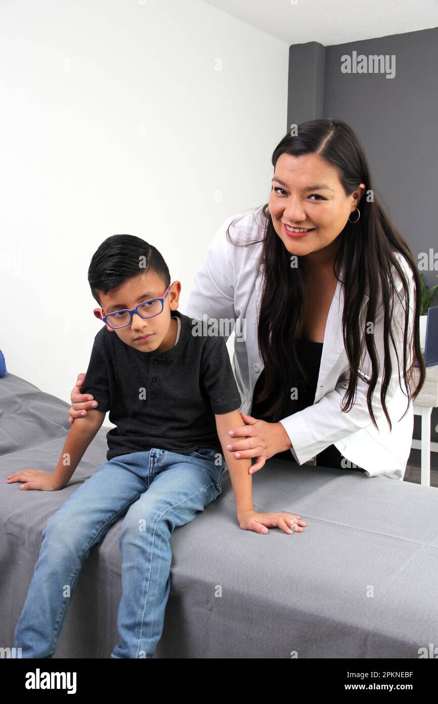 Latina doctor and boy patient with autism spectrum disorder, a ...