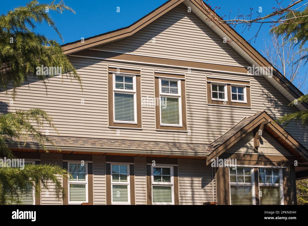 Facade of a house with nice windows in the blue sky background ...