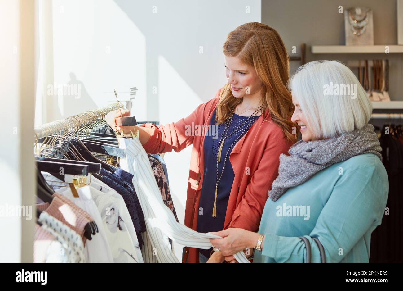 They share a similar taste in clothing. a mother and daughter shopping ...