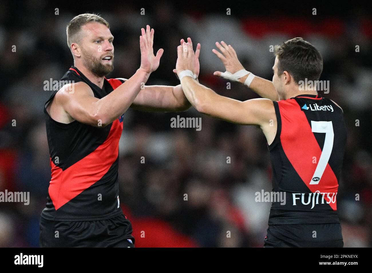 Jake Stringer of Essendon (left) celebrates with team mates after ...
