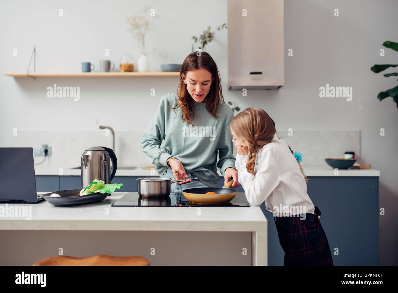 Mother cooks food at home in the kitchen Stock Photo - Alamy