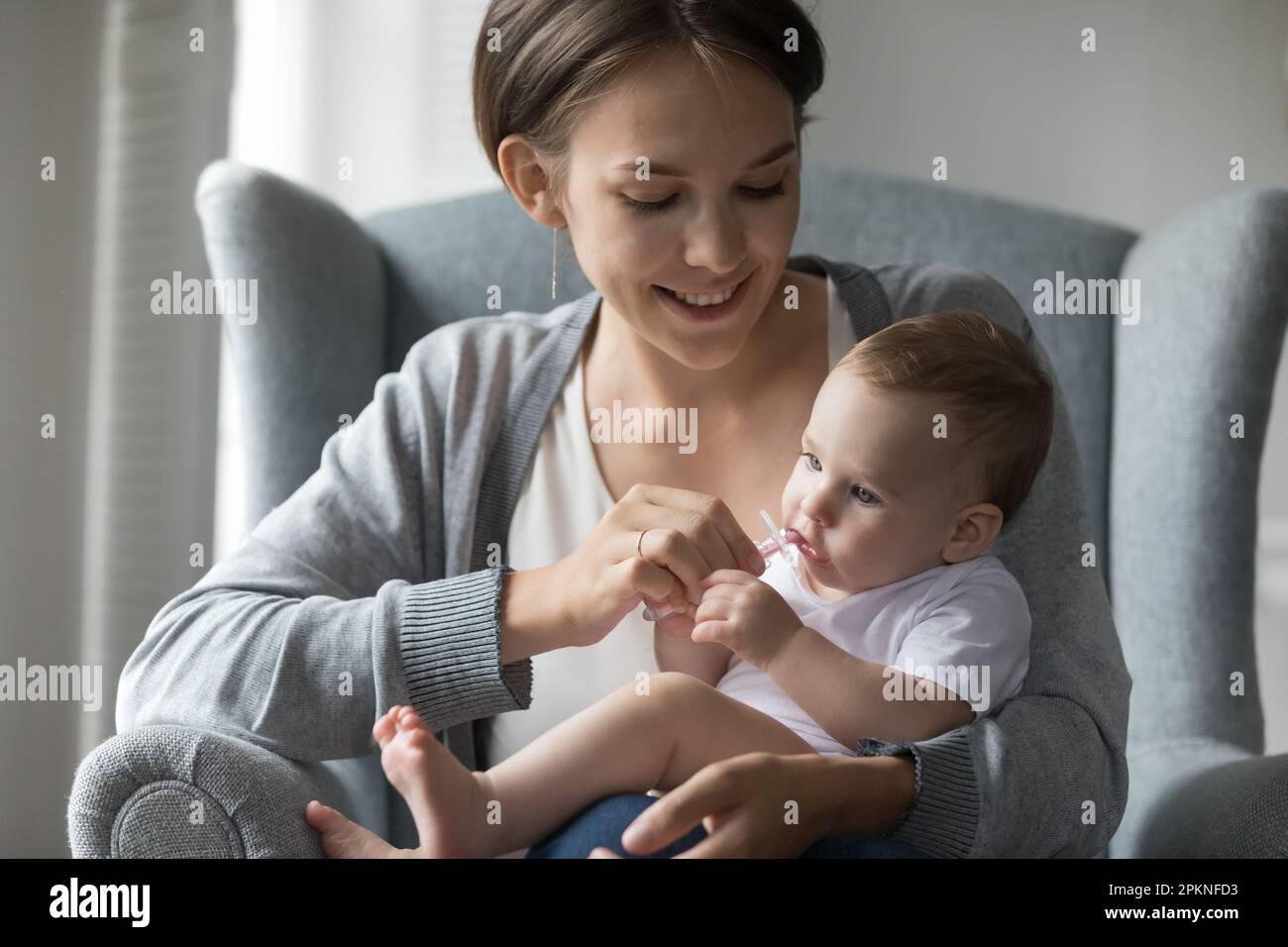 Woman rocking chair holding baby hi-res stock photography and images ...