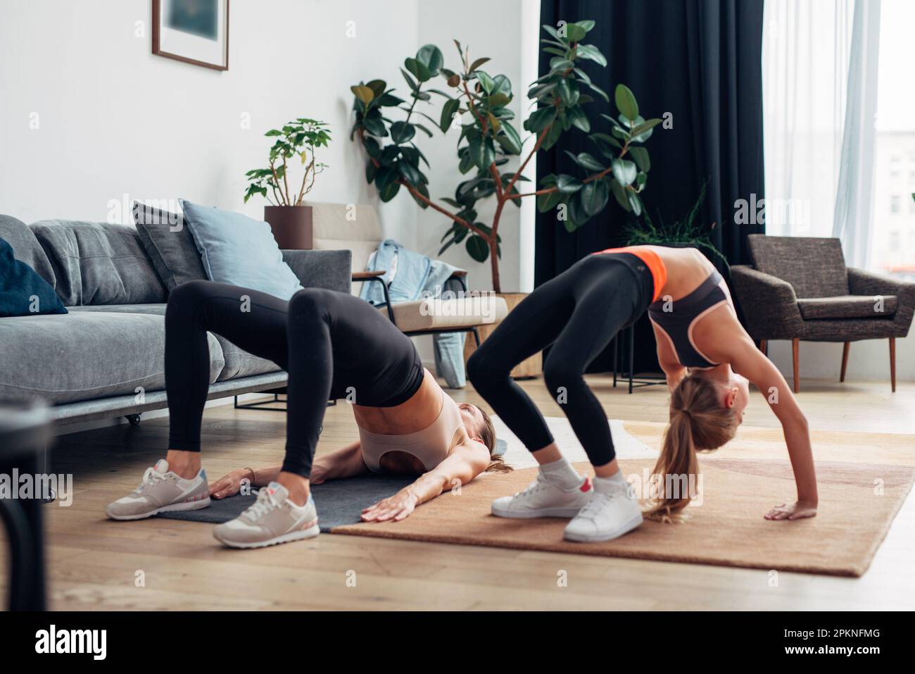Home workout mother and daughter do bridge and gluteal bridge Stock ...