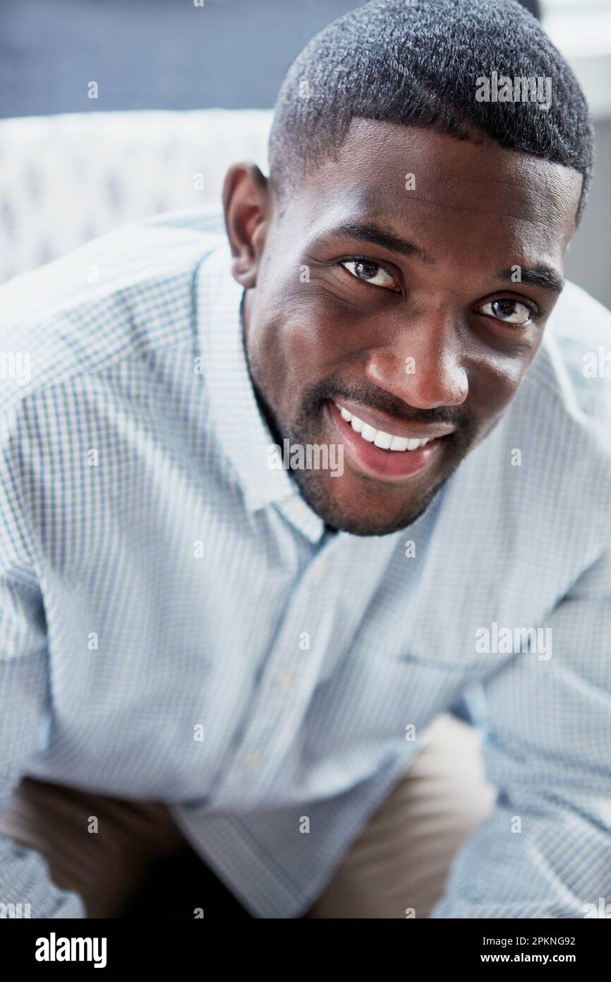 At home for the weekend. Portrait of a happy young man relaxing on the ...