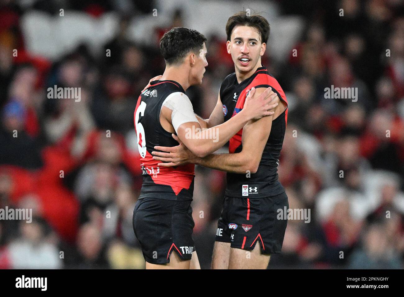 Nic Martin of Essendon (right) celebrates with team mates after kicking ...