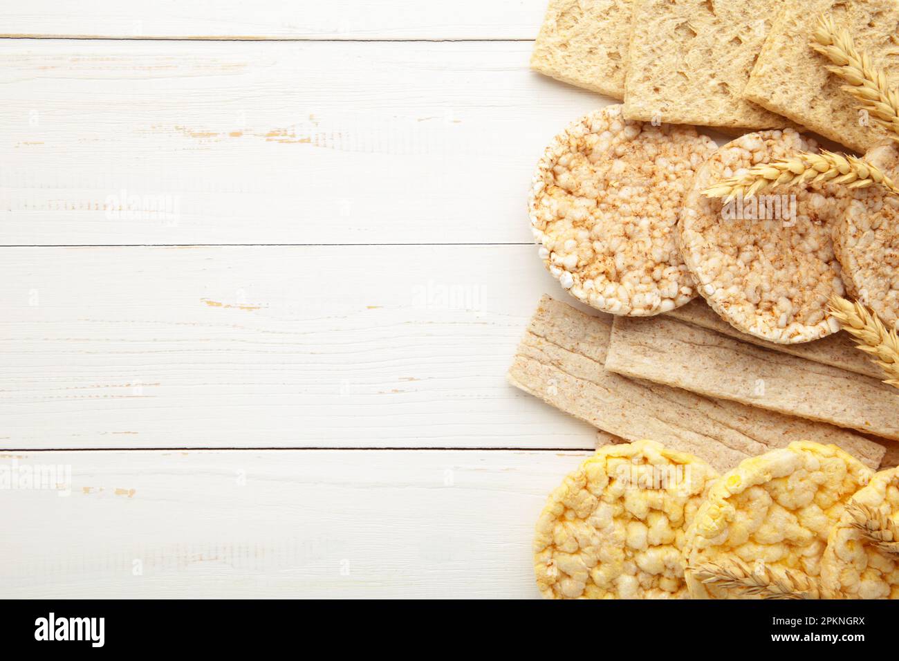 Various types of healthy whole grain crispbreads on white wooden ...