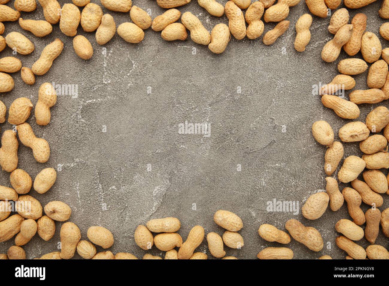 Peanuts in shells on grey background. Top view Stock Photo - Alamy