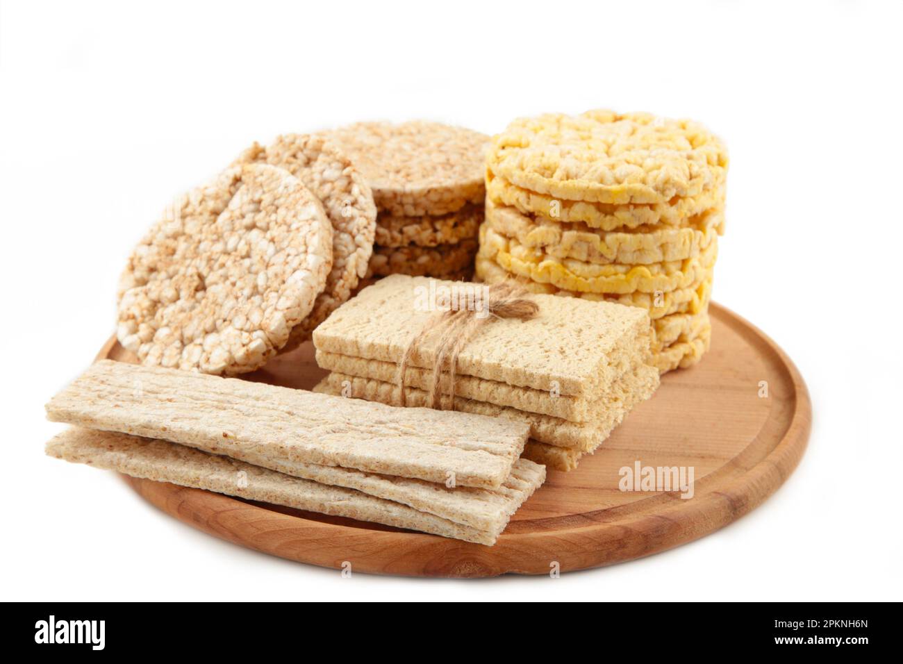 Various types of healthy whole grain crispbreads on cutting board ...