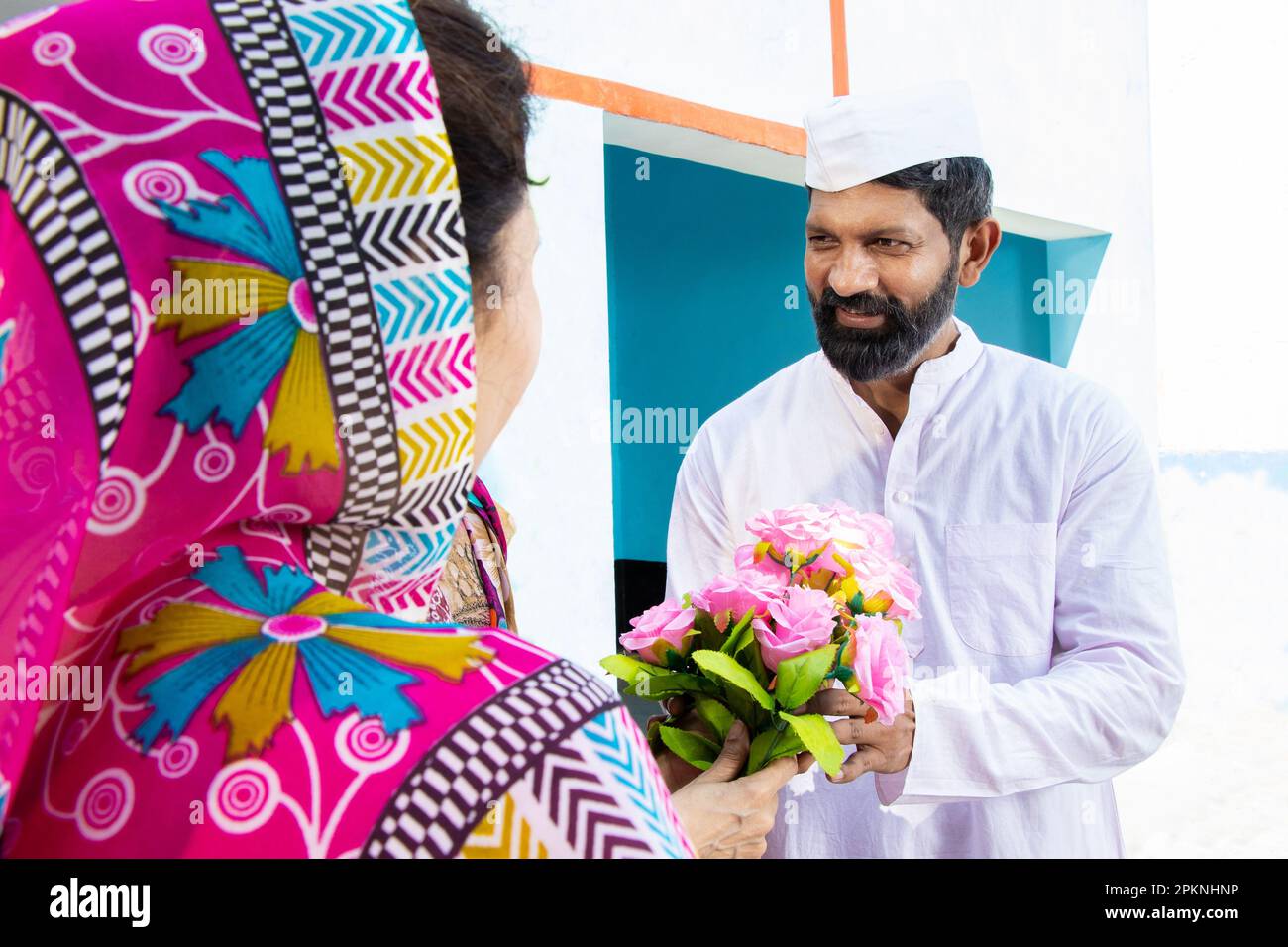 Indian man politician receive bouquet of flower by woman wearing sari ...