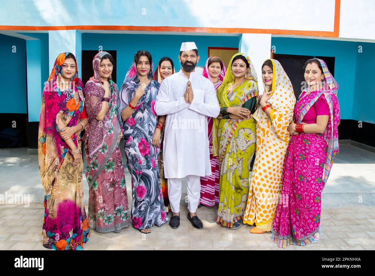 Indian man politician standing doing namaste with group of traditional ...