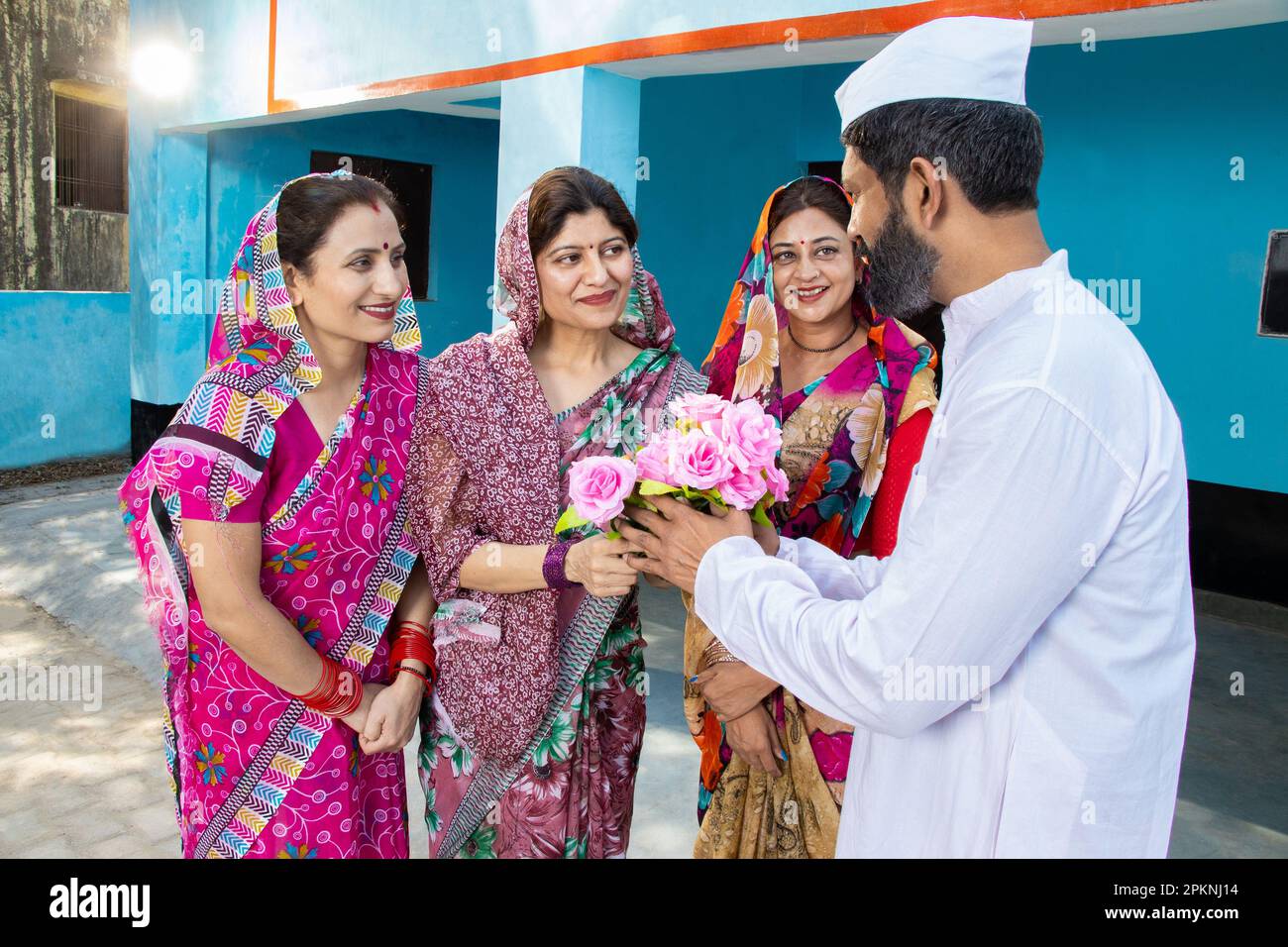 Indian man politician receive bouquet of flower by group of traditional ...