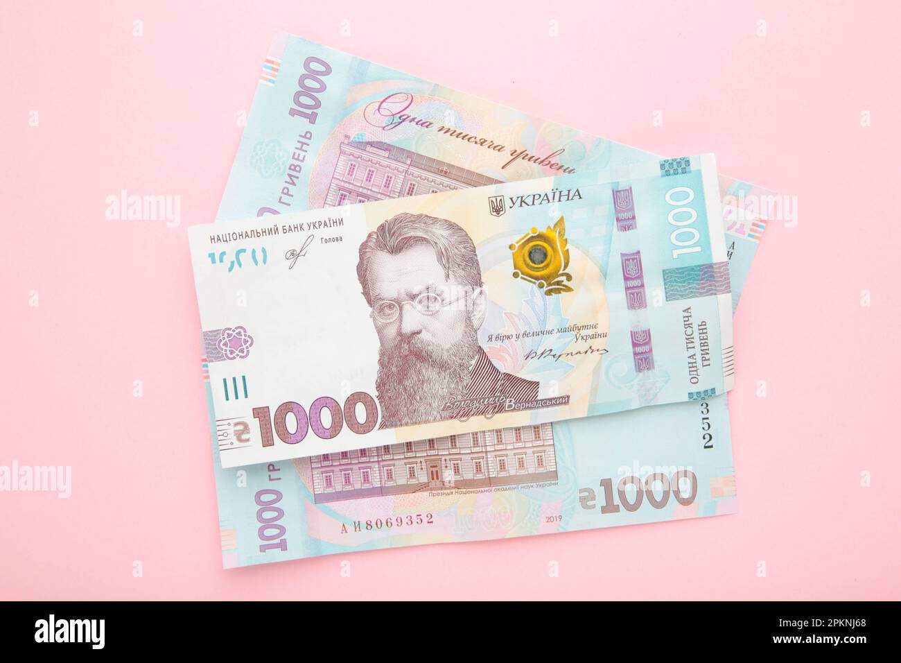 1000 new banknote of Ukraine on pink background. Save and money ...
