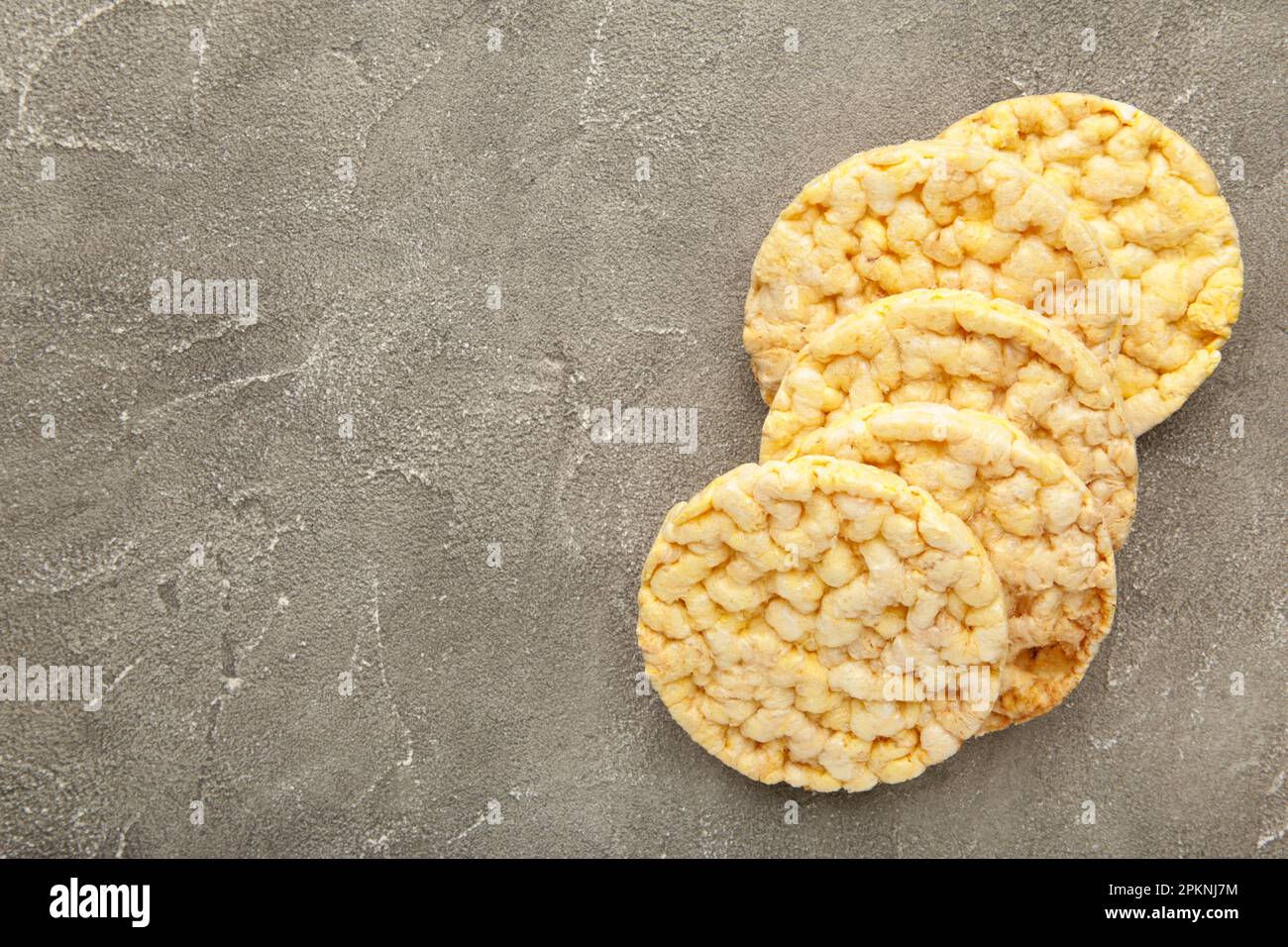Corn round crispbread, crunchy multigrain cereal seeds on grey ...