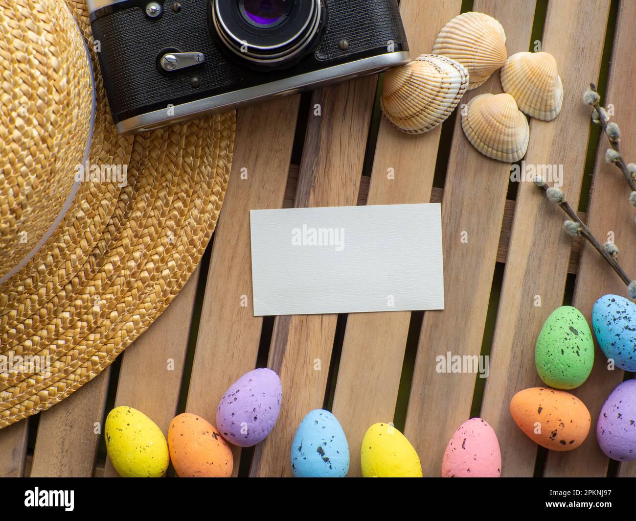 Easter background with straw hat, photo camera, colorful eggs and white ...