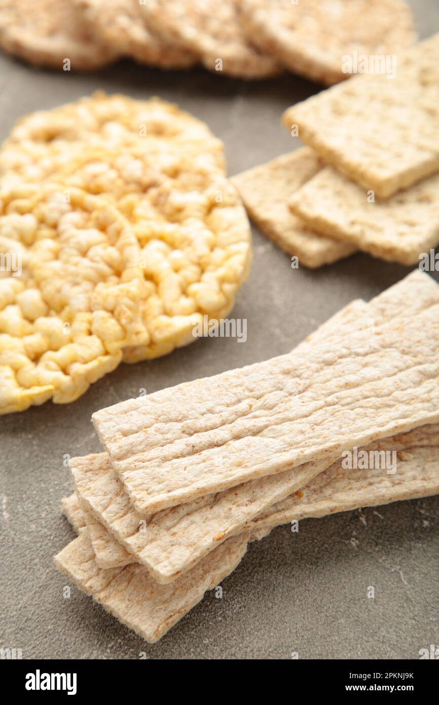 Various types of healthy whole grain crispbreads on grey wooden ...