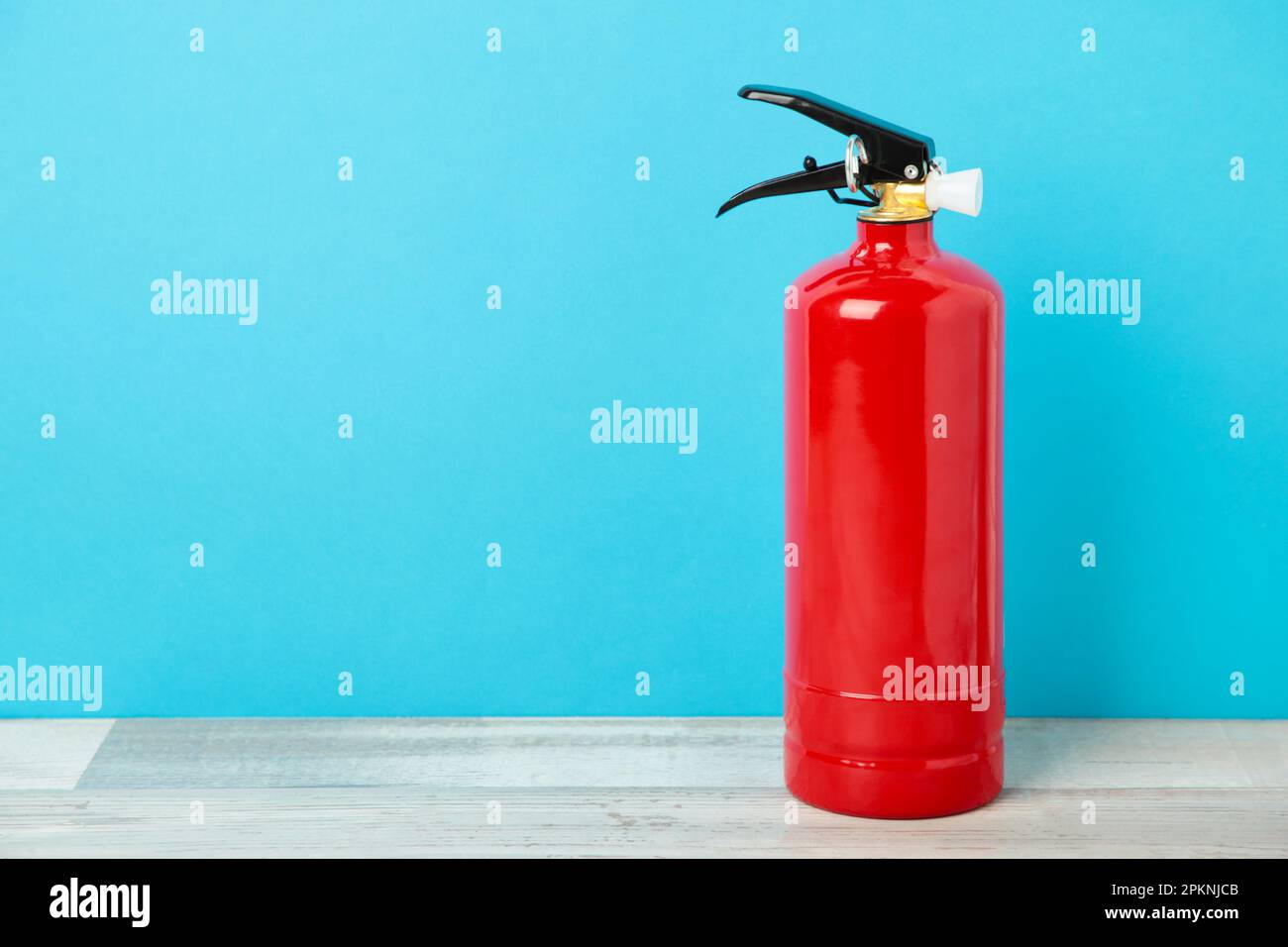 Fire extinguisher on a blue background with clipping path. Top view ...