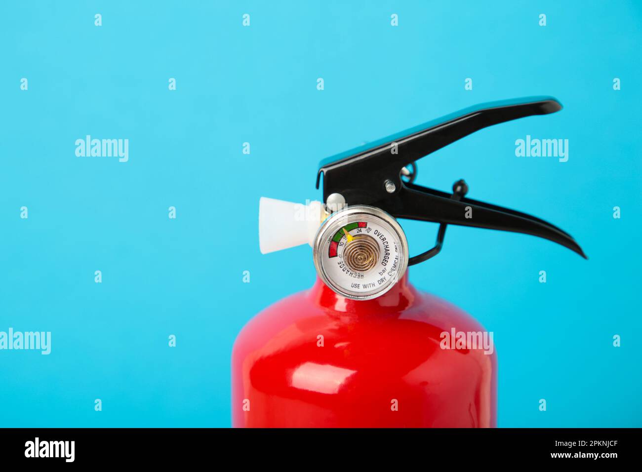 Red foam fire extinguisher on blue background. Top view Stock Photo - Alamy