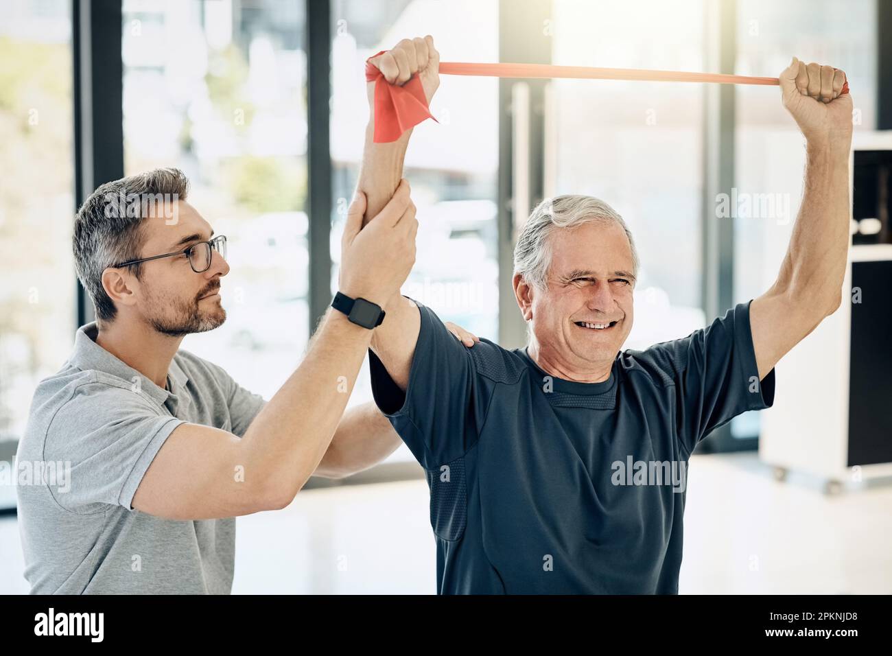 Keeping his strength up. a friendly physiotherapist helping his mature ...