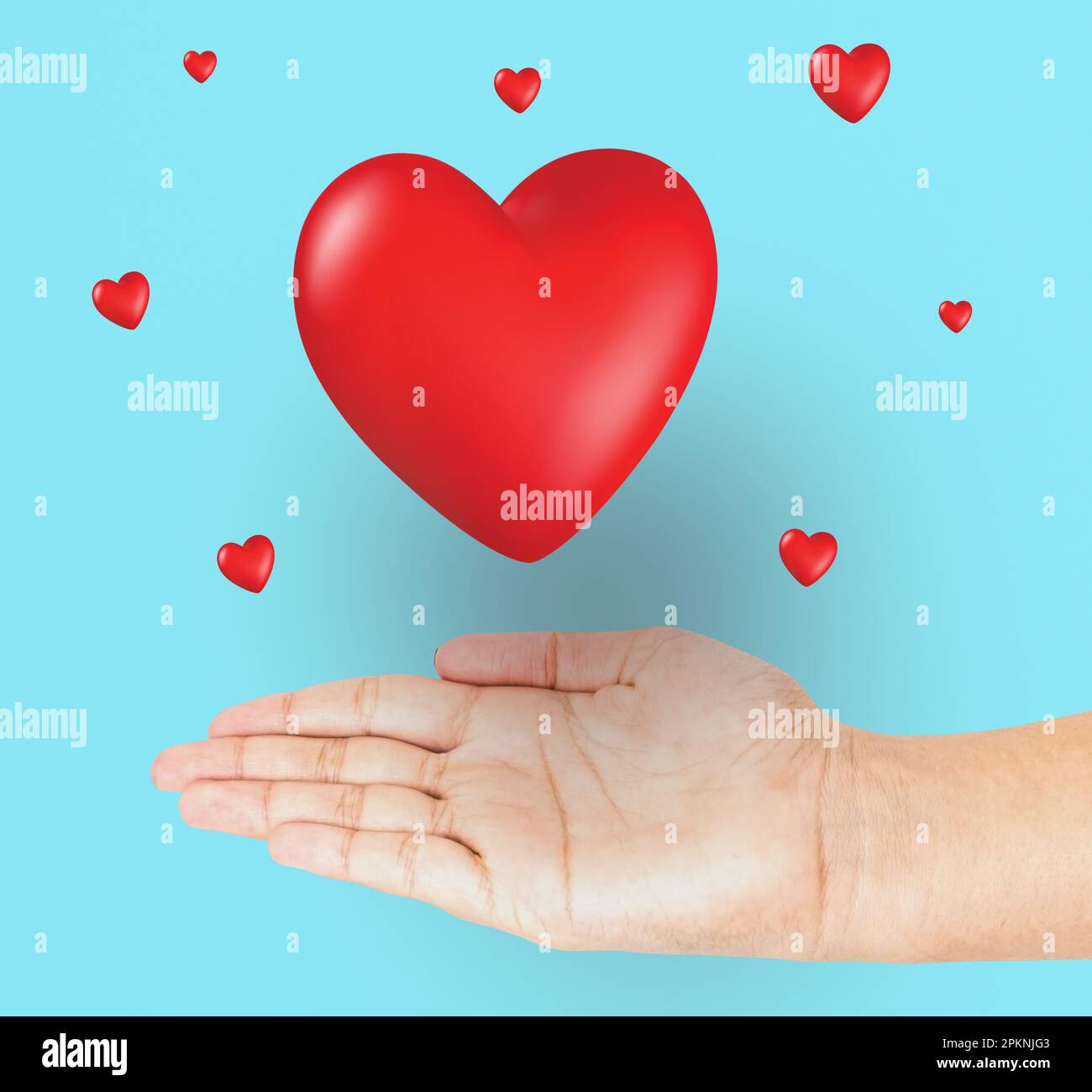Hand with heart shape isolated on light blue background Stock Photo - Alamy