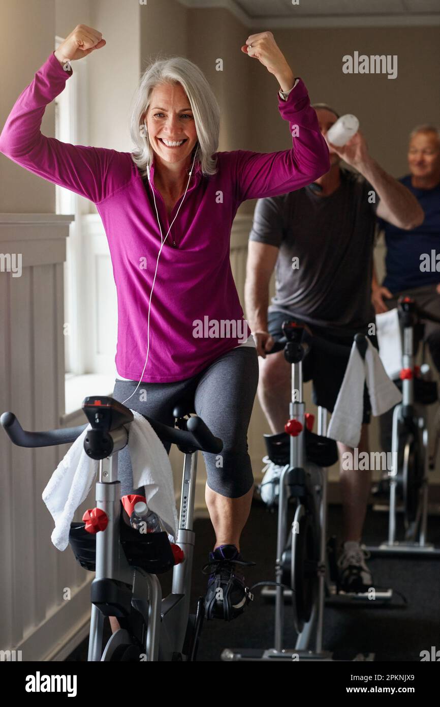 Yes I did it. a group of seniors having a spinning class at the gym ...