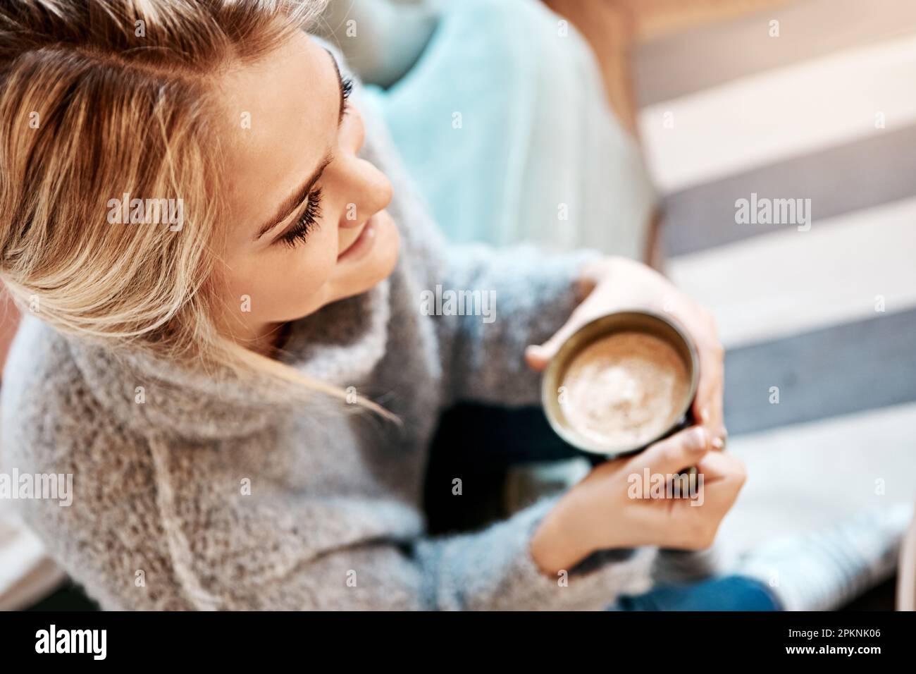Downtime done right. a young woman relaxing on the sofa at home with a ...