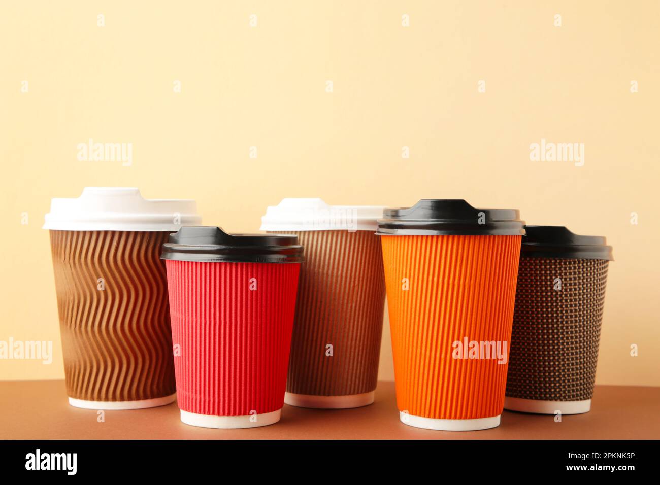 Many different cups of coffee on beige background. Hot beverages Stock ...