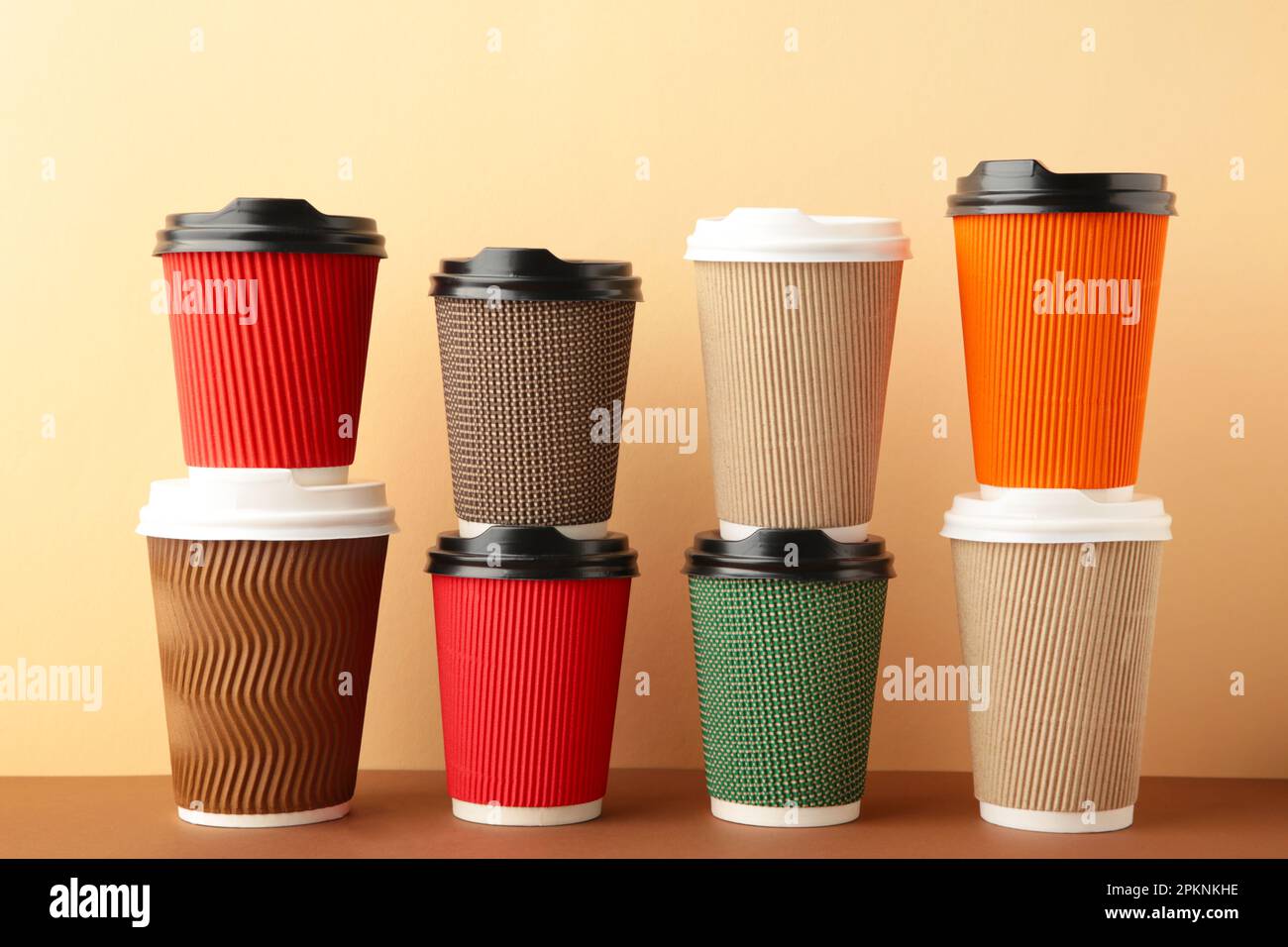 Many different cups of coffee on beige background. Hot beverages Stock ...