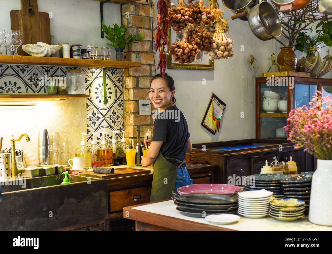 Vietnamese happy waitress working in a kitchen of a cafe Stock Photo ...