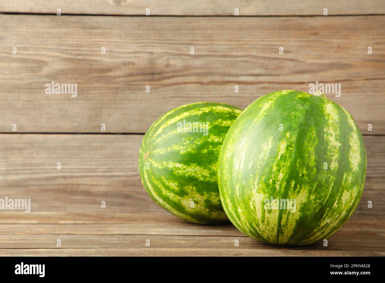 Two fresh watermelons on grey background with copy space . Top view ...