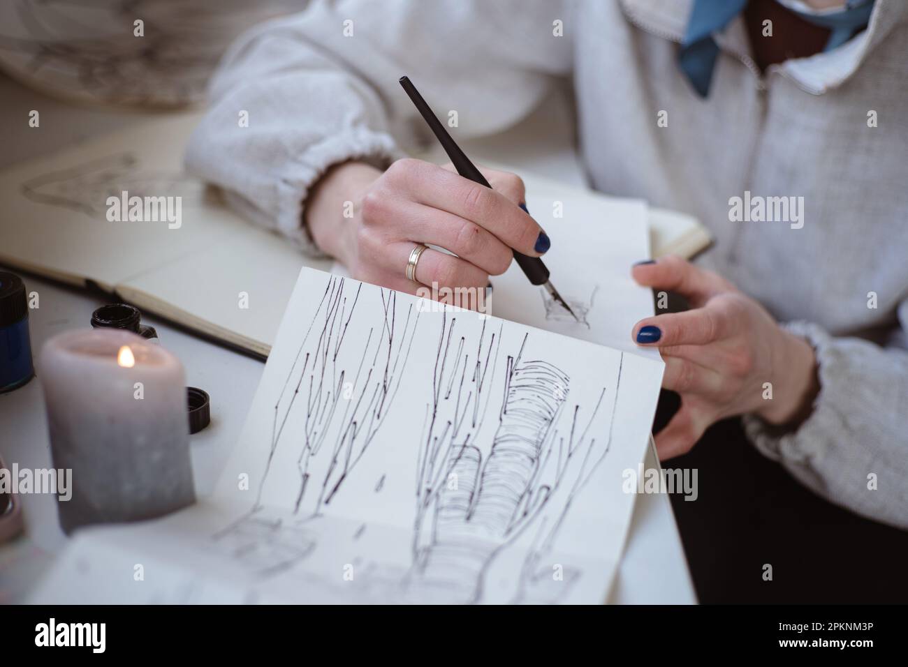 Female artist drawing painting with pen and black ink. Graphic Painting ...