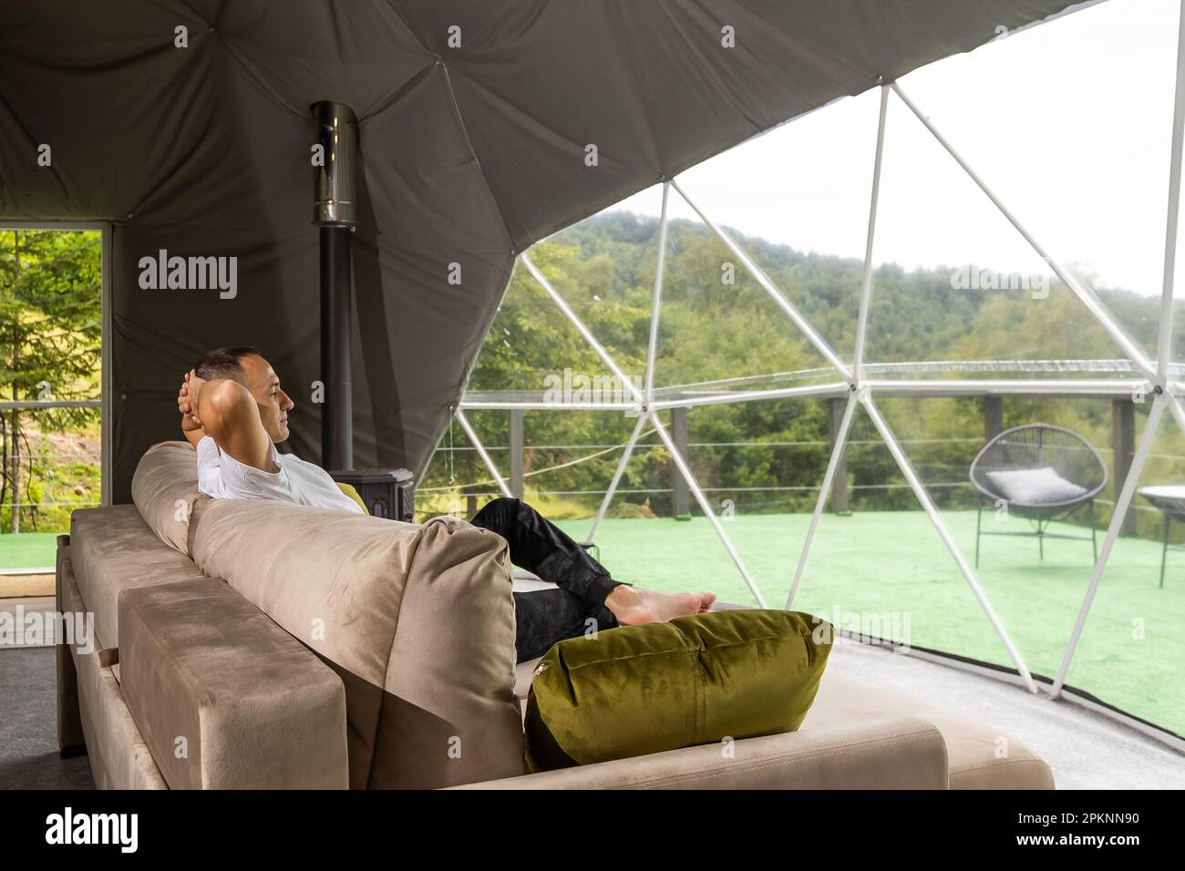 young man resting outside the city in glamping Stock Photo - Alamy