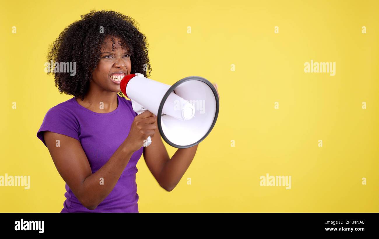 African woman yelling while using a mefaphone Stock Photo - Alamy