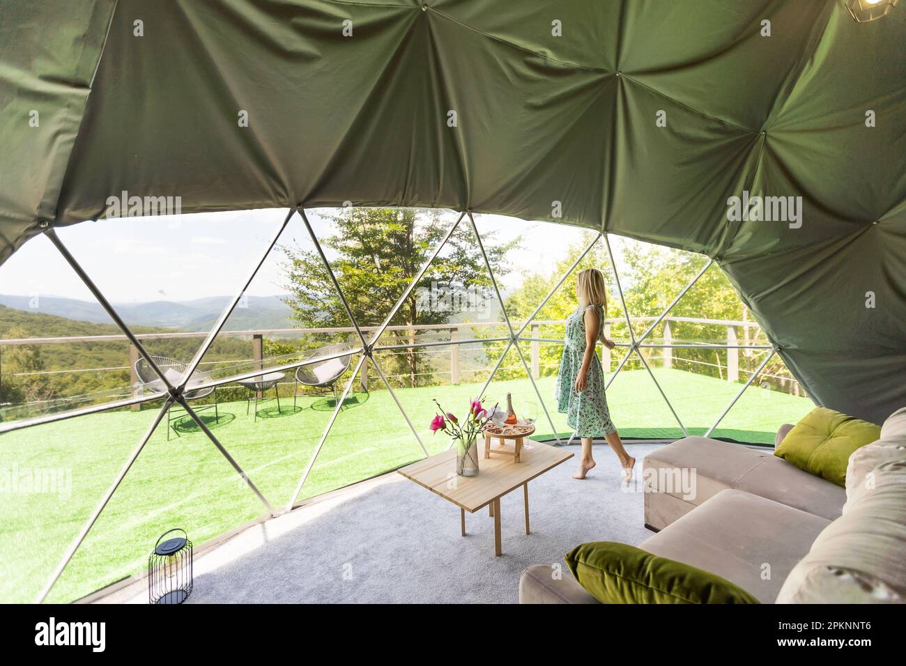 a woman enjoys solitude inside of a transparent bubble hotel Stock ...