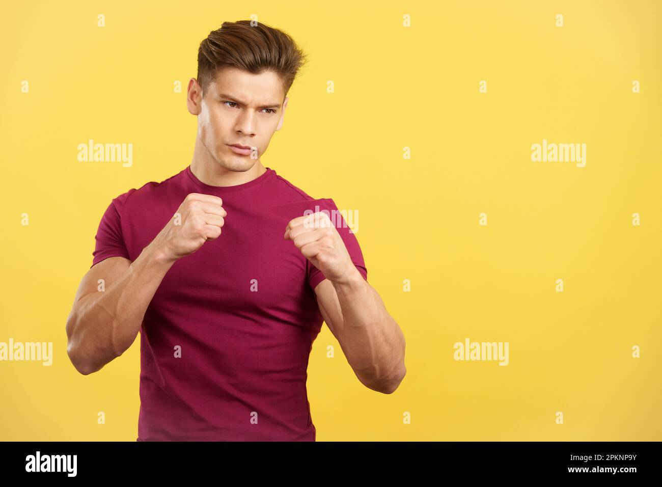 Strong man in combat pose raising fists in boxing guard Stock Photo - Alamy