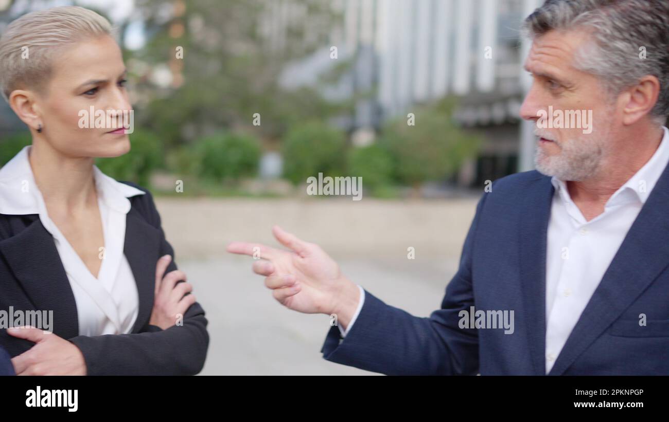 Boss gives a task to a businesswoman in the street Stock Photo - Alamy