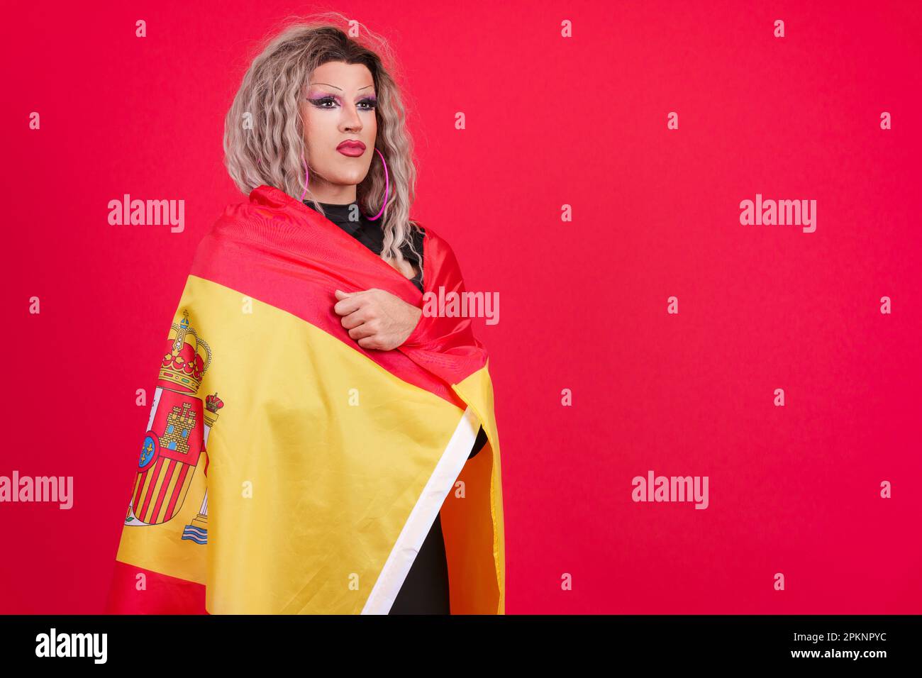 Serious transgender person wrapping with a spanish flag Stock Photo - Alamy