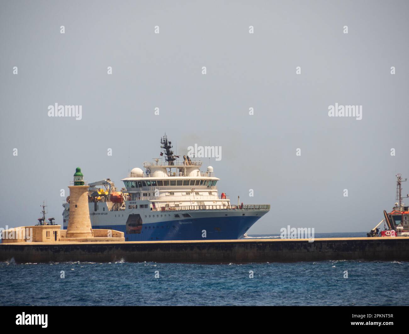 Valletta, Malta - May 2021. A huge cargo ship leaving the port. Neptune ...