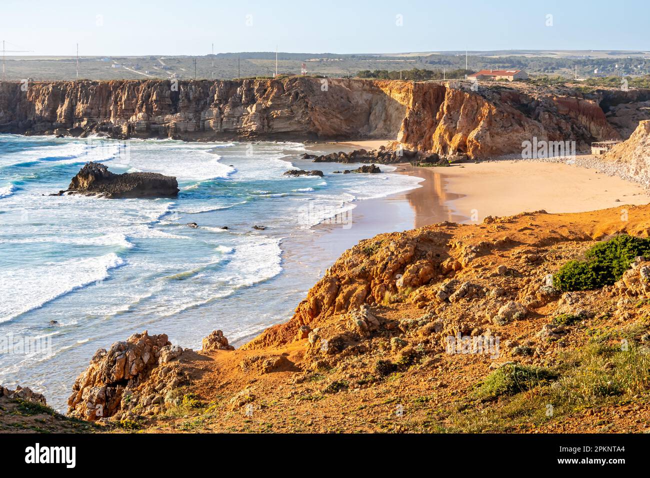 The idyllic, empty surf spot Praia do Tonel beach is bathed in warm ...